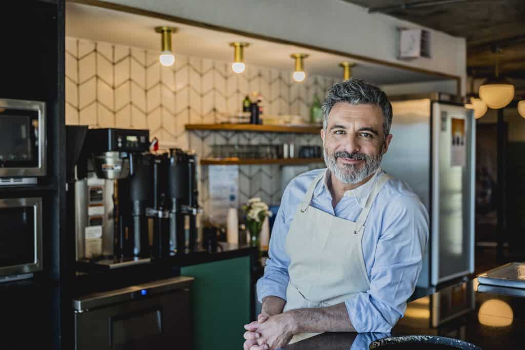 Smiling male barista ready to prepare drink in coffee bar | Knight-Dik ...